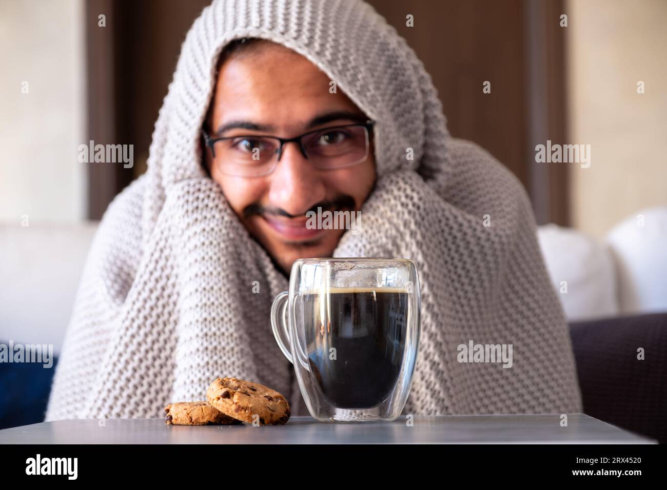 bearded male drink coffee while Covered In A Woolen Blanket in winter ...