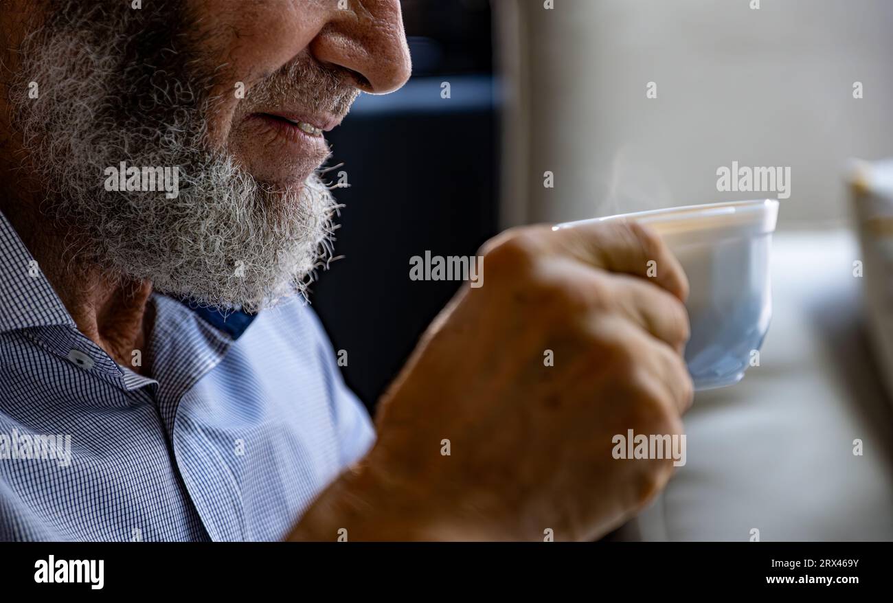 Old man drinking coffee with smile on his face Stock Photo - Alamy