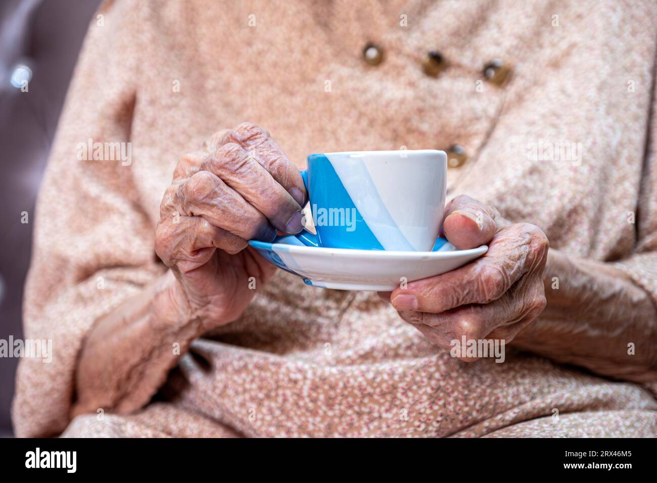 Old woman drinking coffee with smile on her face Stock Photo - Alamy