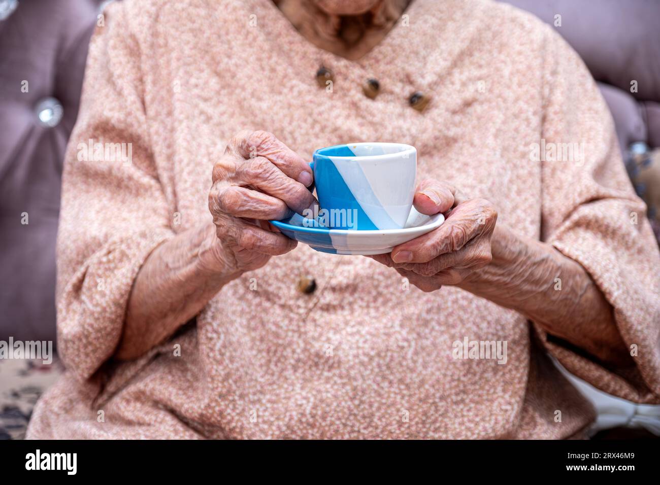 Old woman drinking coffee with smile on her face Stock Photo - Alamy