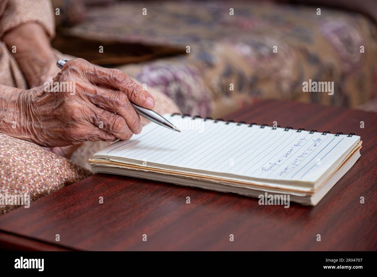 wrinkled hands for elderly person writing notes on his note book Stock ...