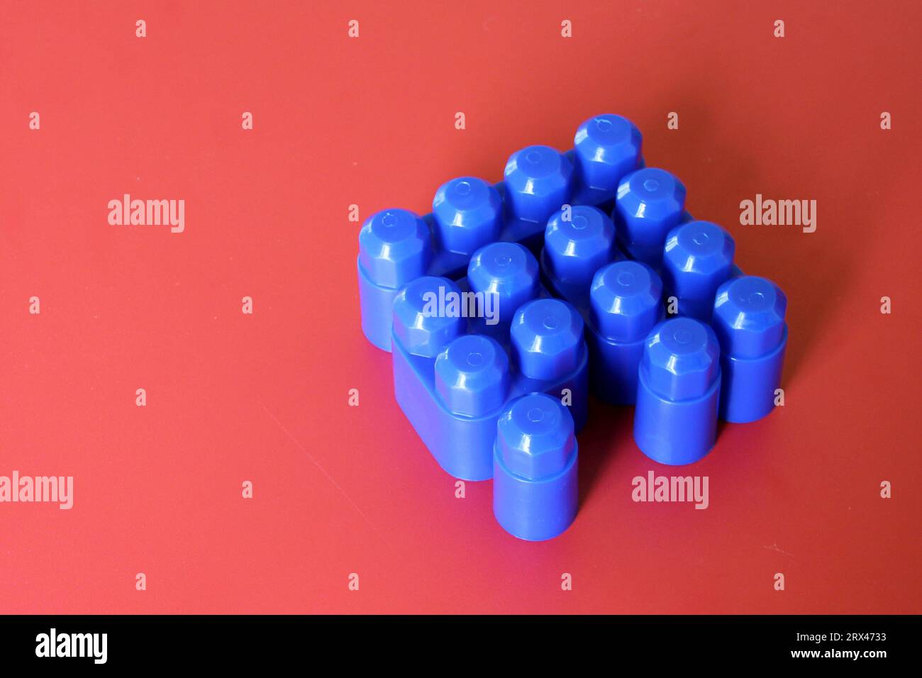 Buildable colored plastic blocks to play, build and organize on a red ...