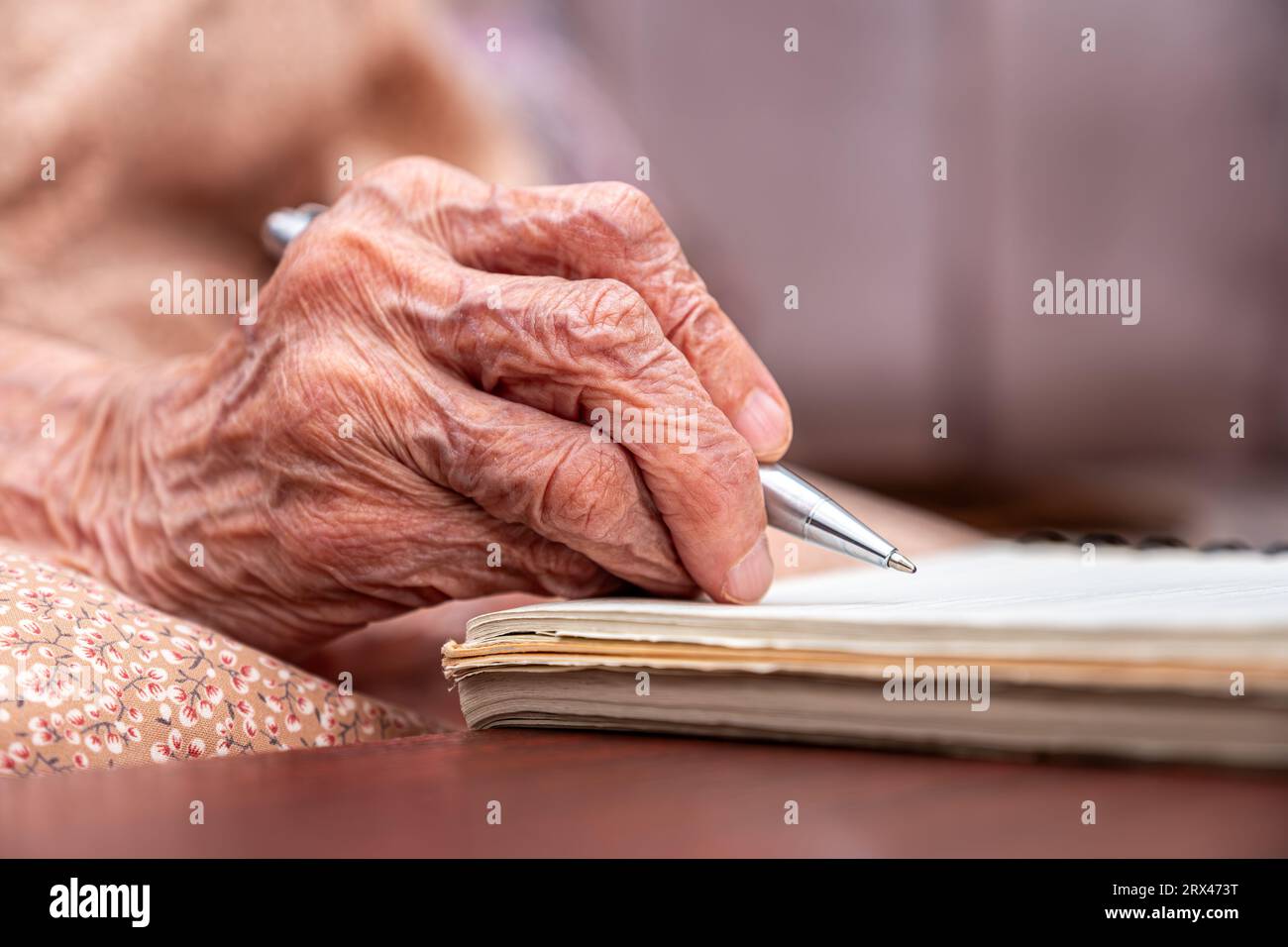 wrinkled hands for elderly person writing notes on his note book Stock ...