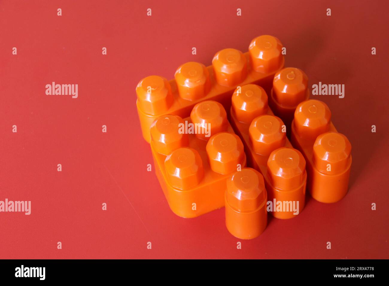 Buildable colored plastic blocks to play, build and organize on a red ...