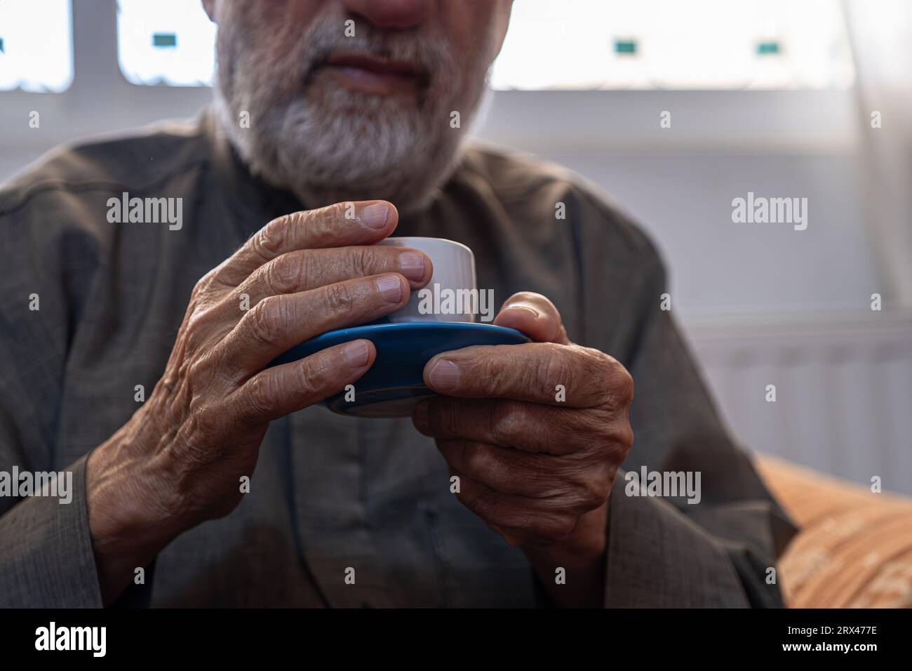 Old man drinking coffee with smile on his face Stock Photo - Alamy