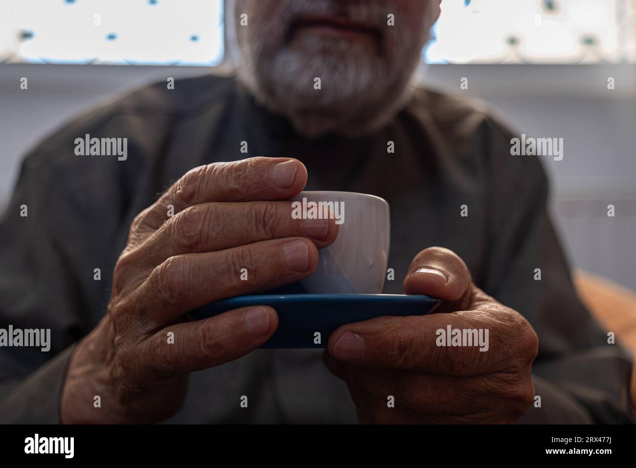 Old man drinking coffee with smile on his face Stock Photo - Alamy