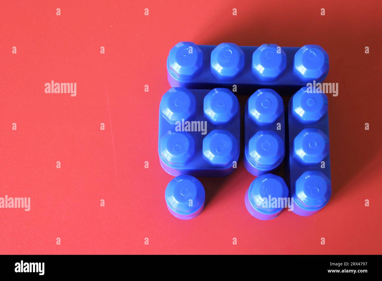 Buildable colored plastic blocks to play, build and organize on a red ...