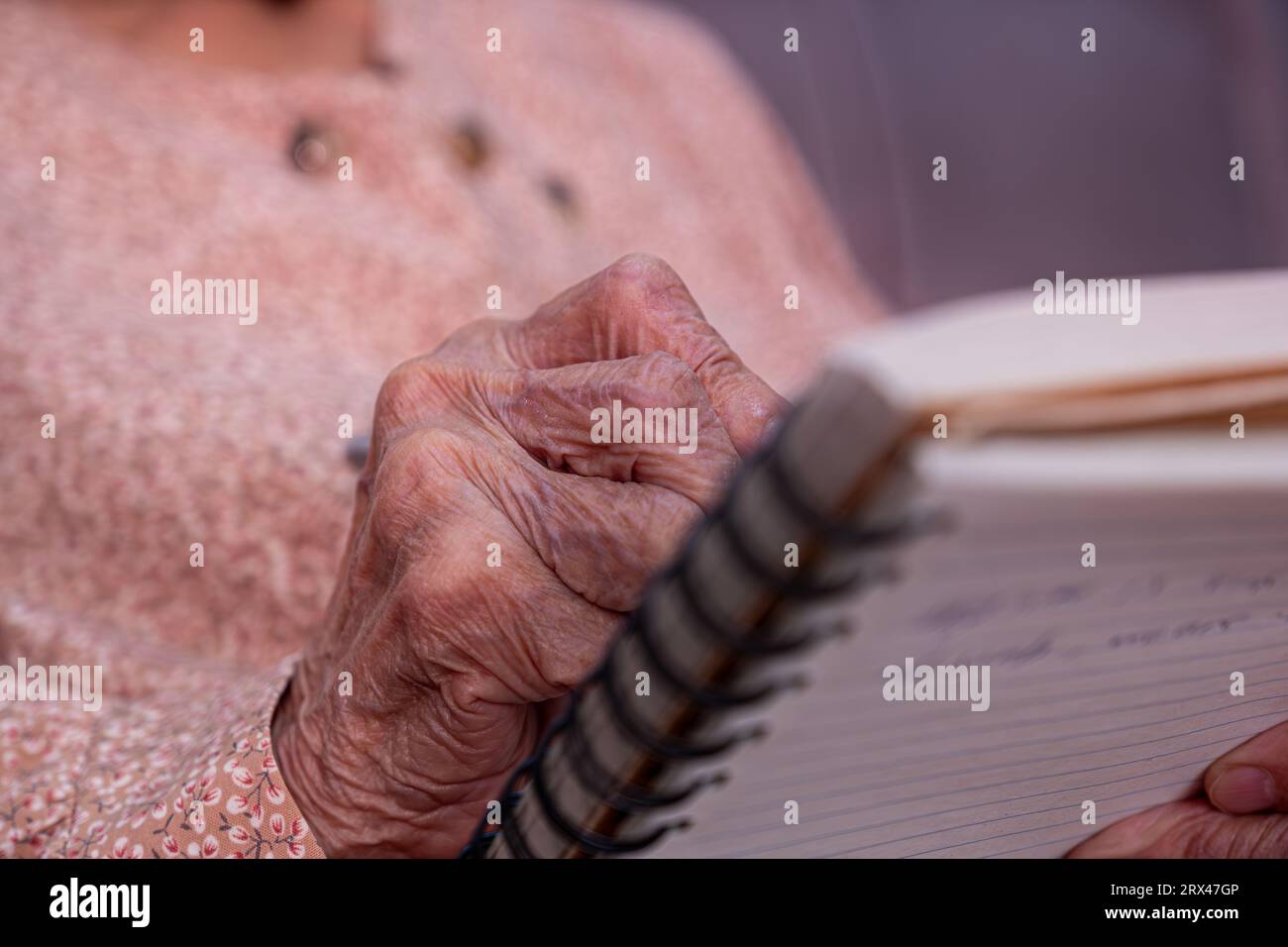 wrinkled hands for elderly person writing notes on his note book Stock ...
