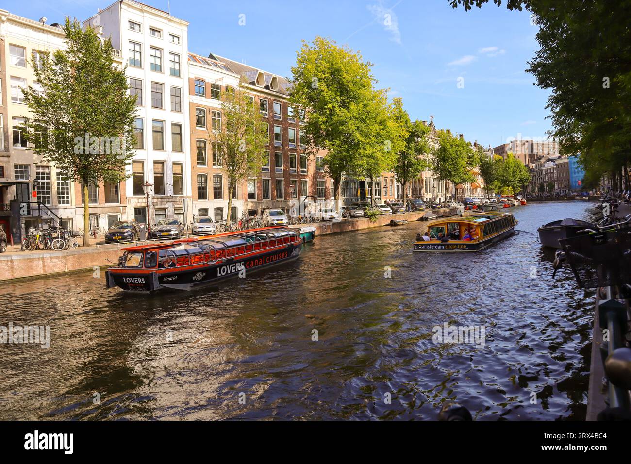 Amsterdam. Amsterdam boat tour canal people. Tourists enjoy riding boat ...