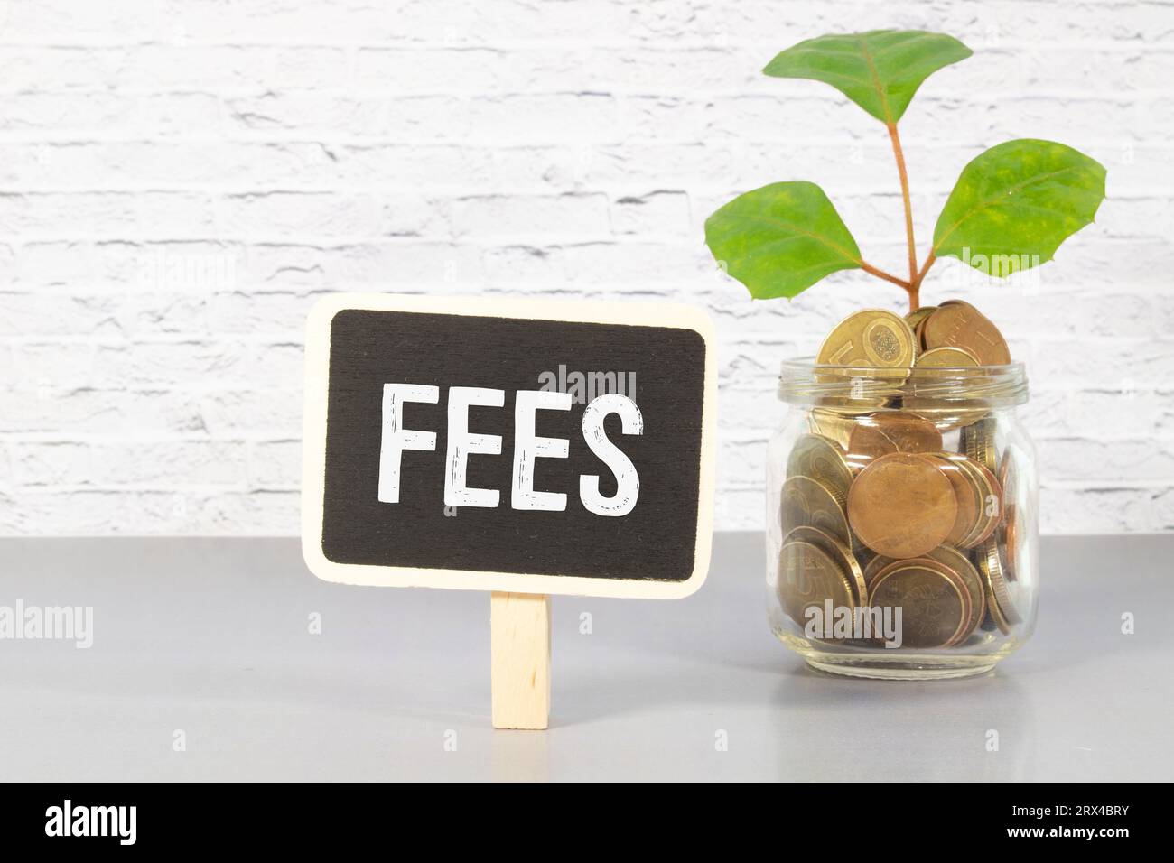 Knowing your bank fees, A piggy bank on a desk with chalkboard with ...