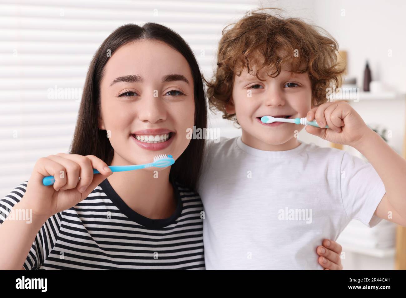 Mother and her son brushing teeth together in bathroom Stock Photo - Alamy