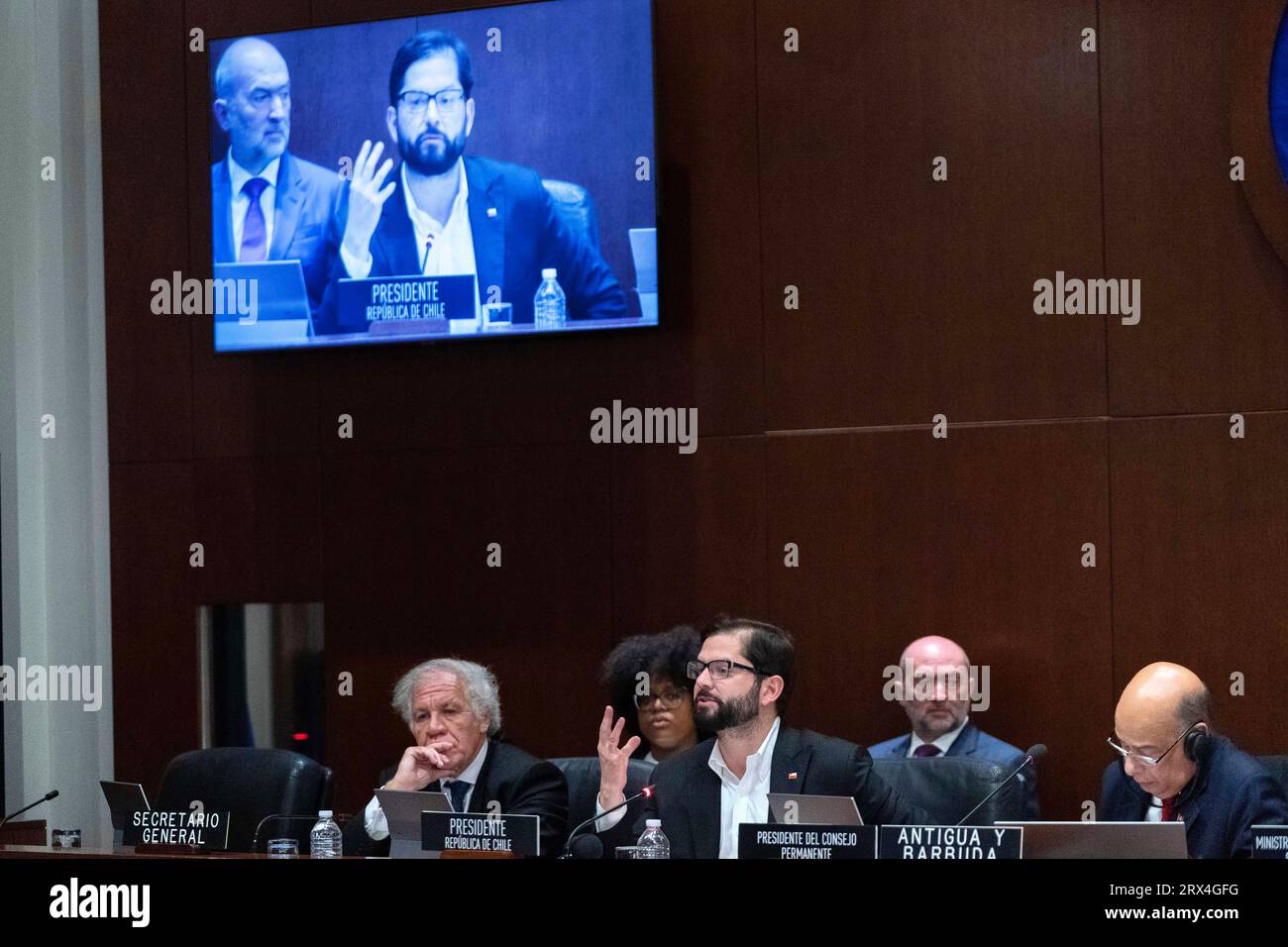 Chile's President Gabriel Boric, center, accompanied by Secretary ...