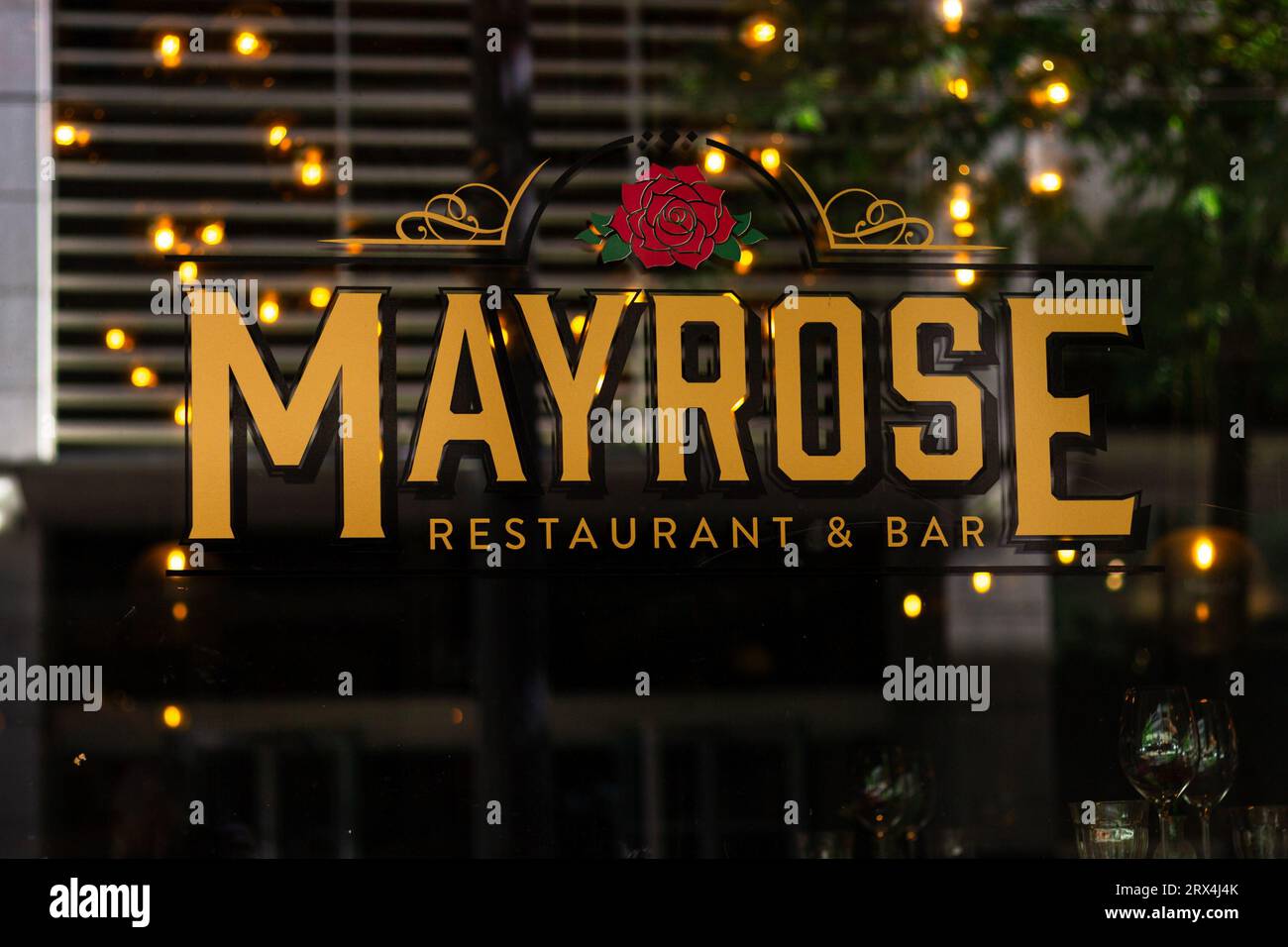 Reflections of lights and a building in the window at Mayrose ...