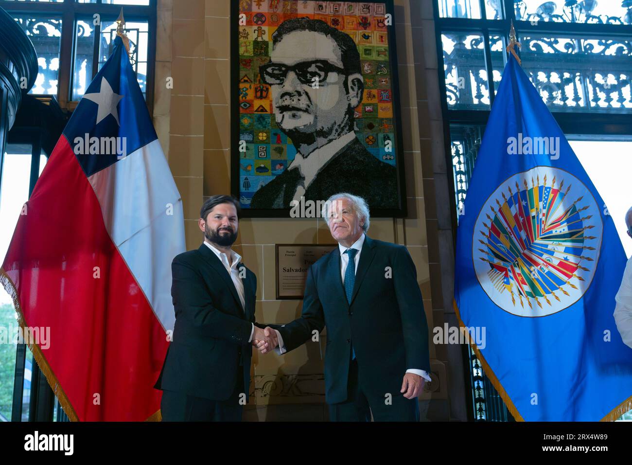 Chile's President Gabriel Boric, left shake hands with Secretary ...