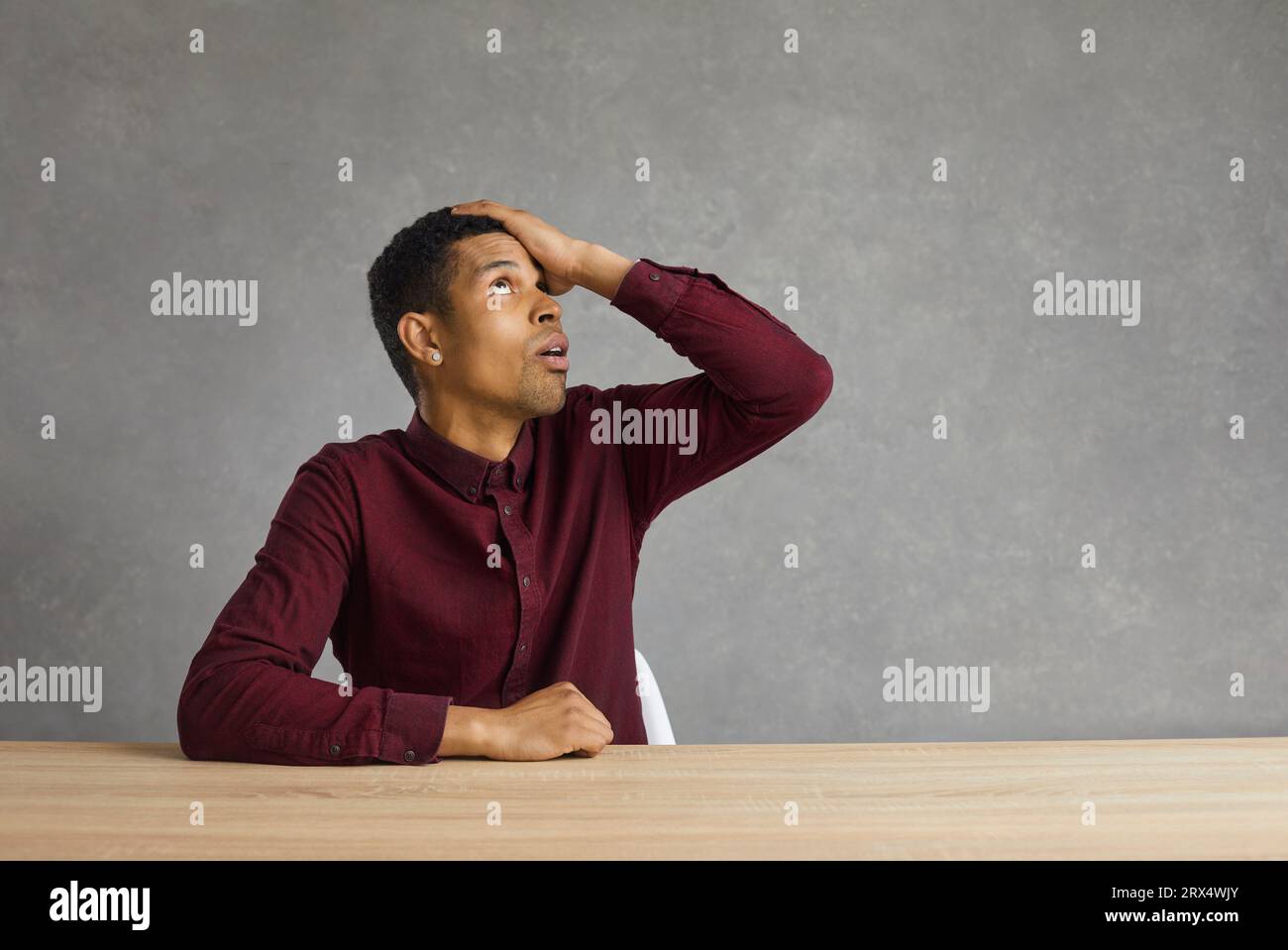 Embarrassed man keeps his hand on his forehead remembering that he ...