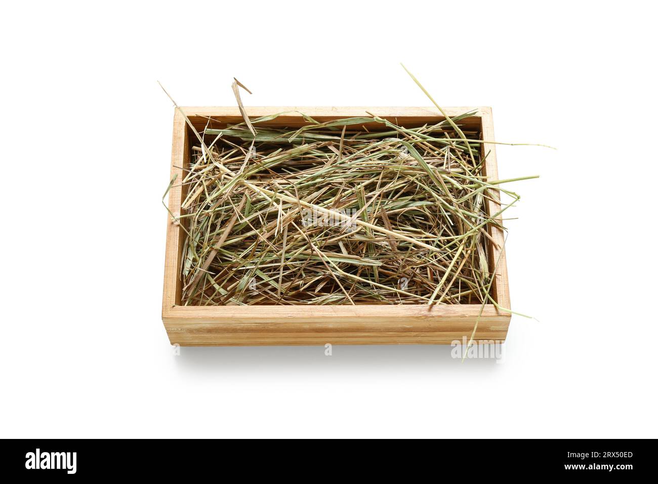 Straw in crate on white background Stock Photo - Alamy