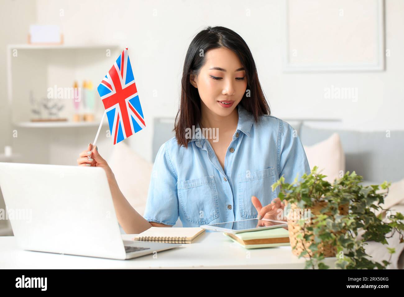 Beautiful Asian woman with UK flag learning English language online at ...