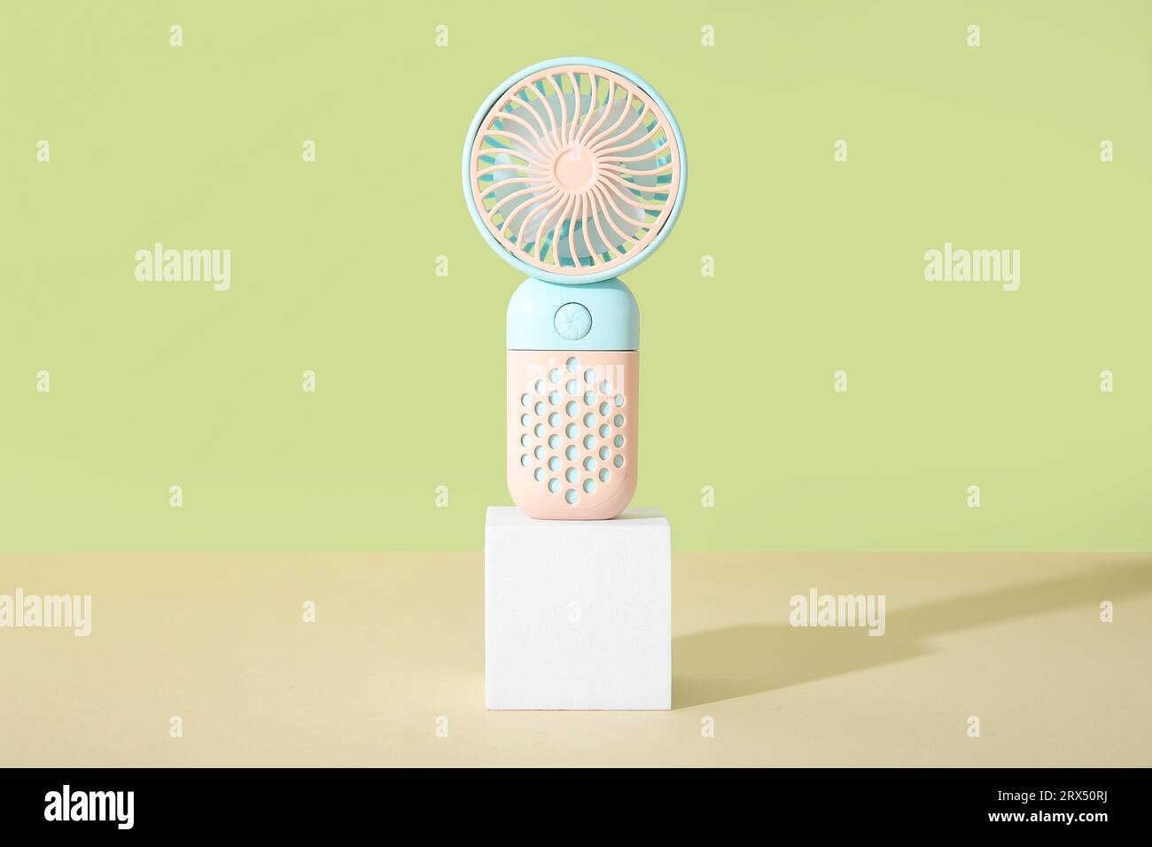 Mini electric fan on beige background Stock Photo - Alamy