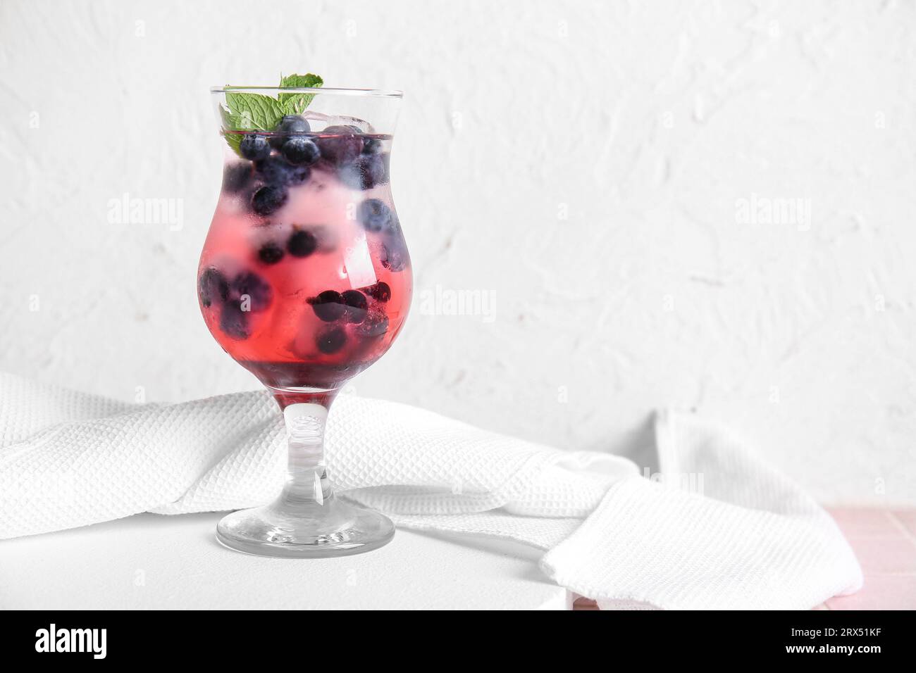 Glass of fresh blueberry lemonade with mint on white background Stock Photo - Alamy
