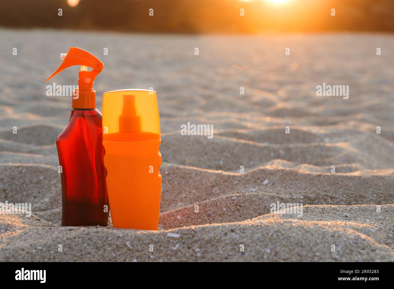 Bottles of sunscreen cream on sand at beach Stock Photo - Alamy