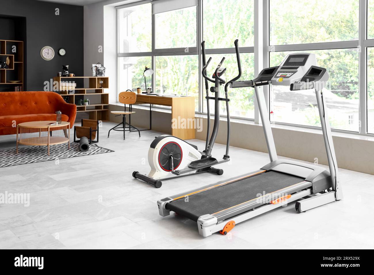 Interior of modern living room with workplace and sports equipment ...