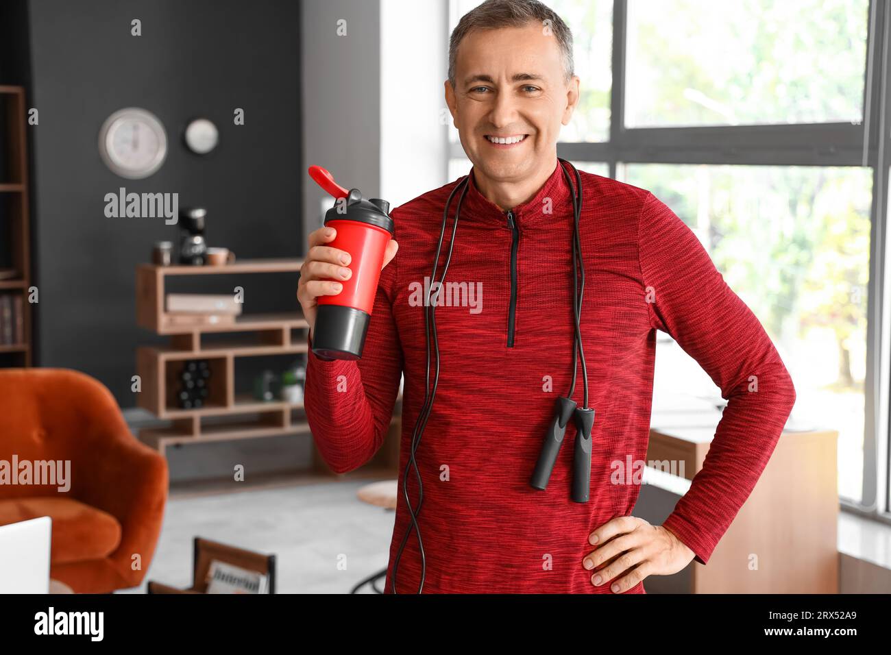 Sporty mature man with bottle of water at home Stock Photo - Alamy