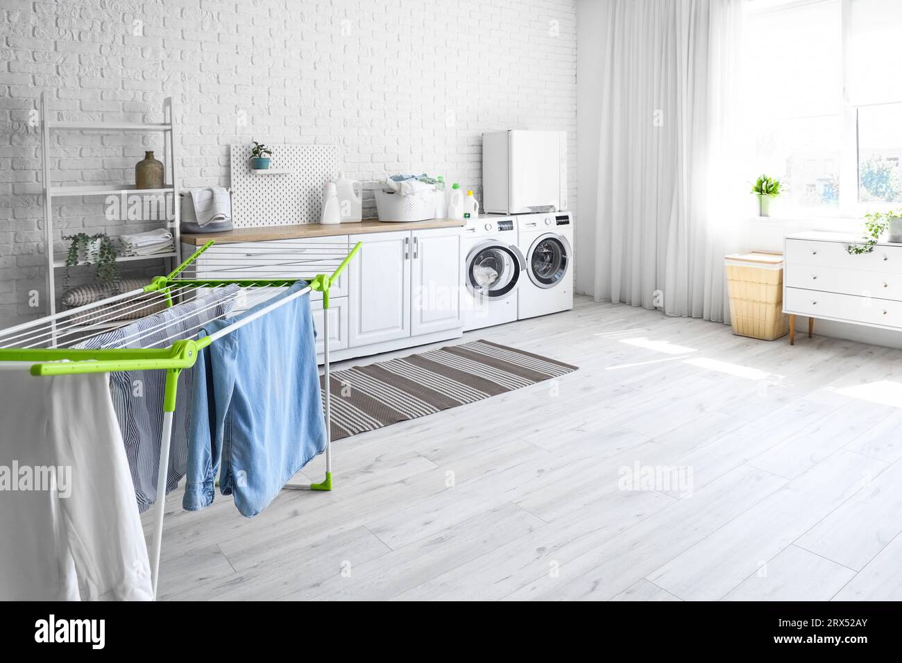 Interior of laundry room with washing machines and dryer Stock Photo ...