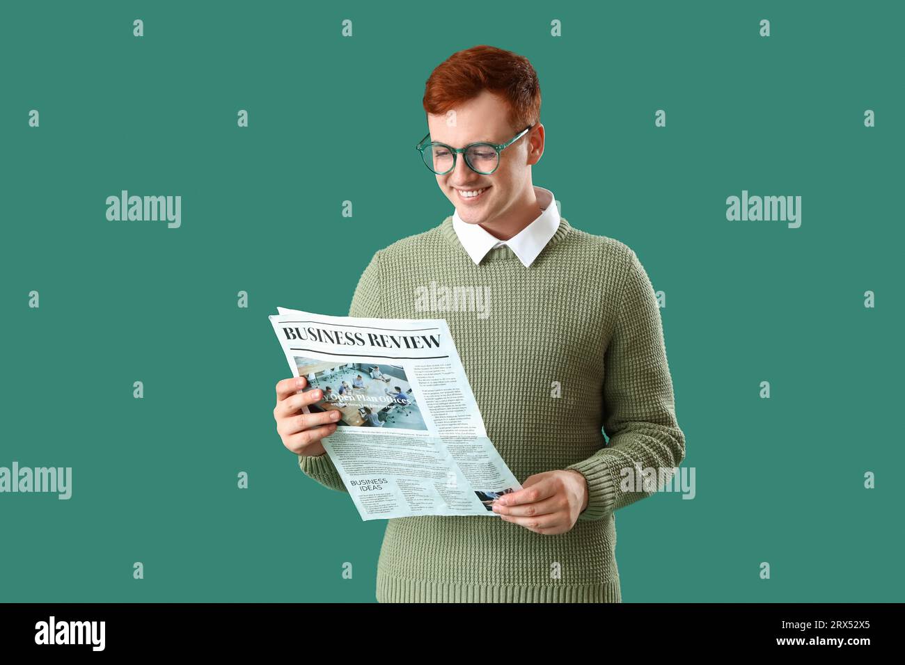 Young business owner reading newspaper on green background Stock Photo ...