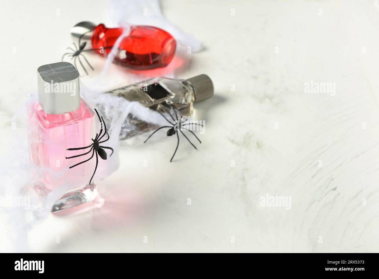 Bottles of elegant perfume with spiderweb for Halloween celebration on ...