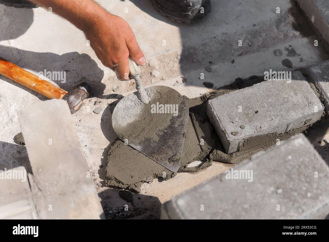 Mason lays out brickwork from gray bricks. Hands of builder with trowel ...