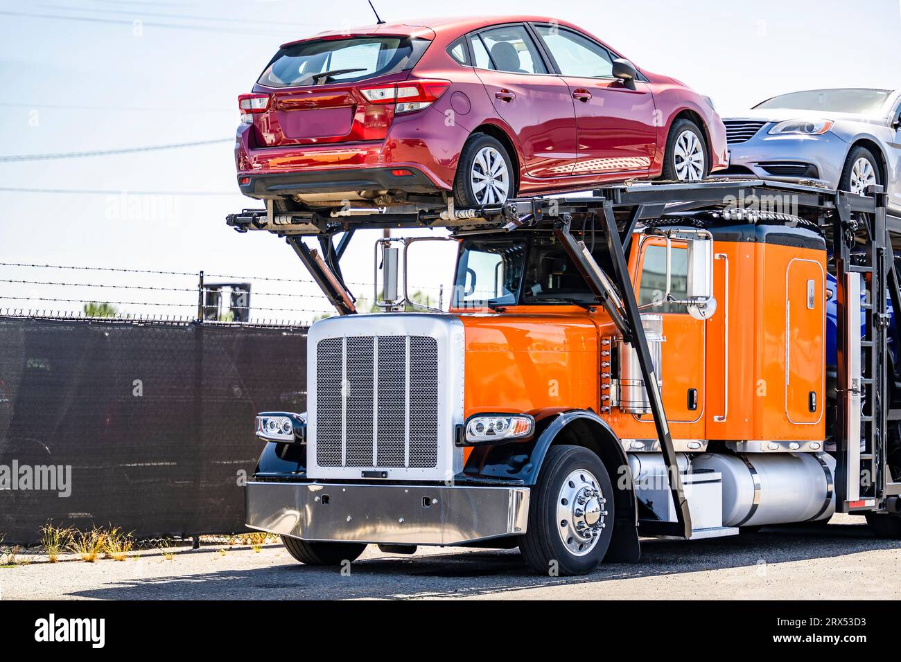 Orange car hauler big rig semi truck tractor with two level hydraulic ...