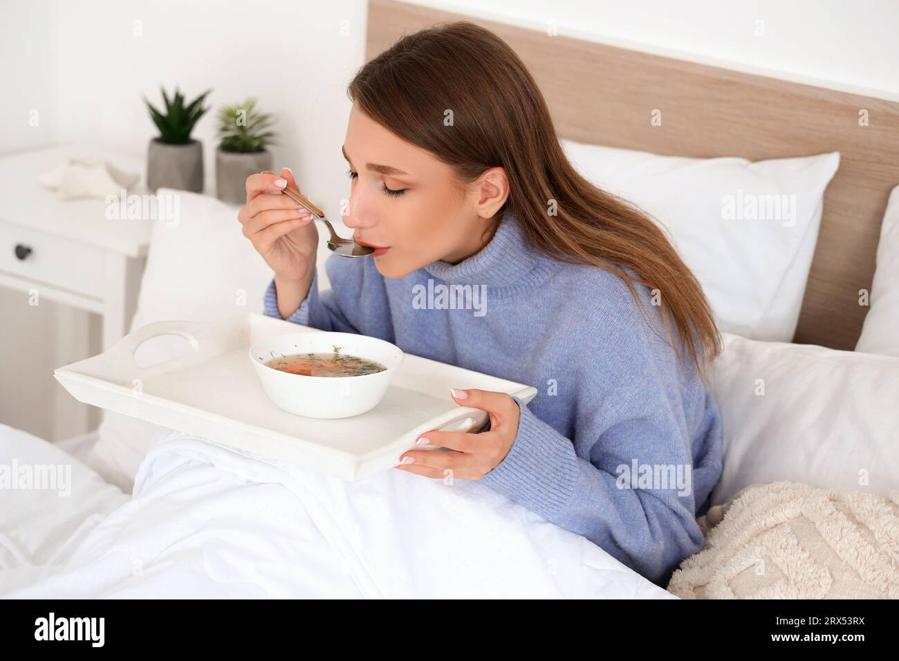 Woman eating in bed soup hi-res stock photography and images - Alamy