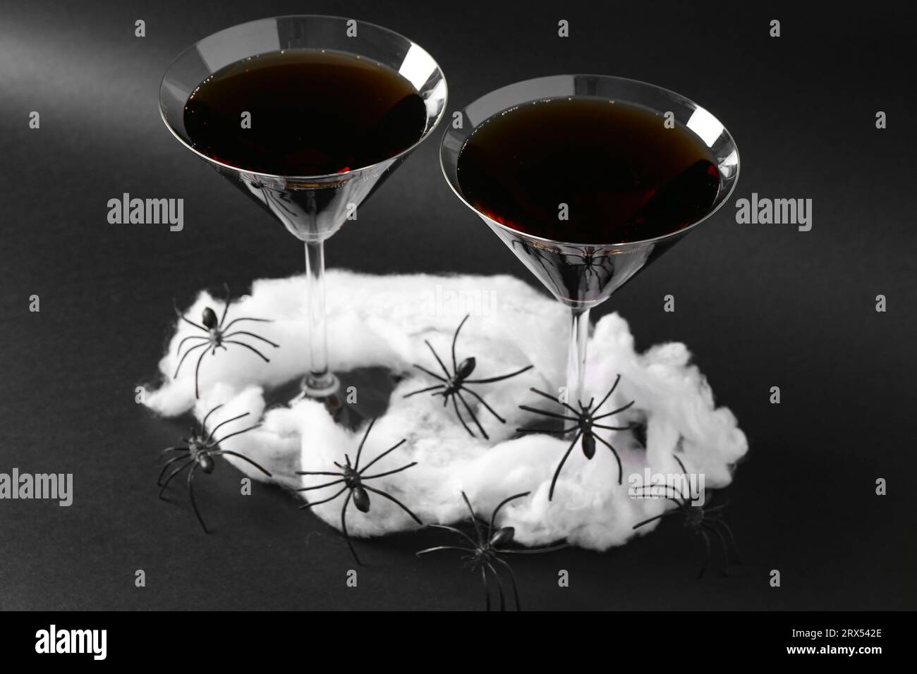Spiders with glasses of tasty cocktail for Halloween celebration on ...