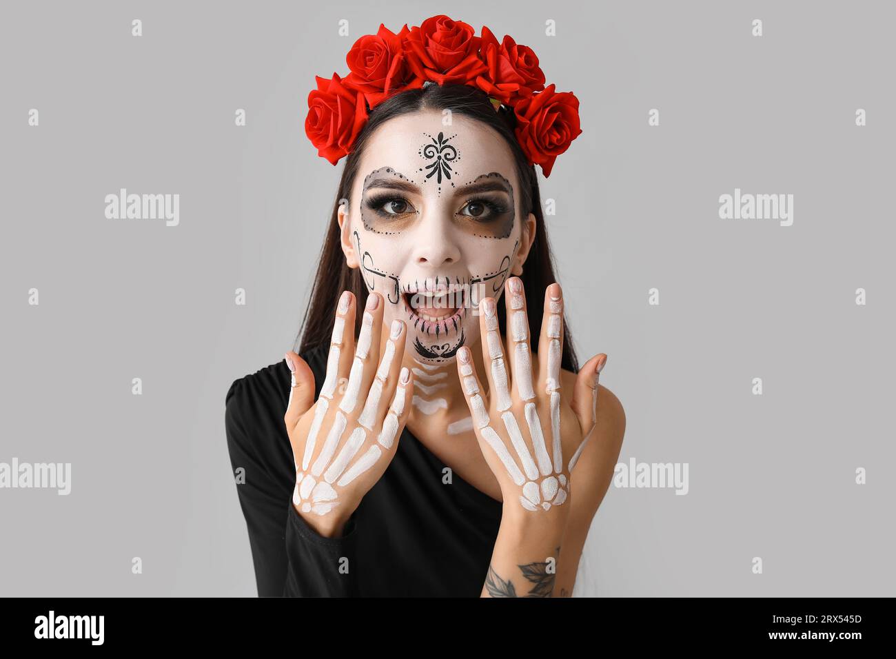 Shocked young woman dressed as dead bride for Halloween party on grey ...