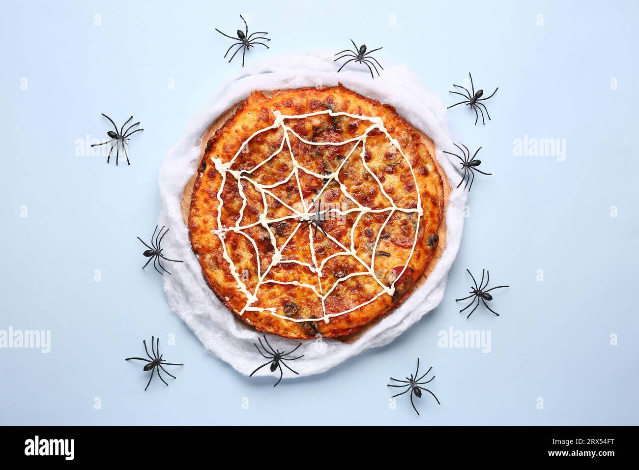 Tasty pizza and spiders for Halloween party on blue background Stock ...