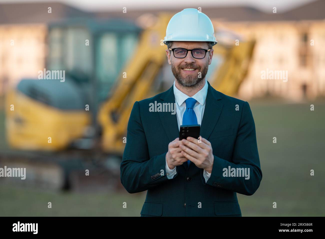 Successful construction business owner. Construction worker in suit and ...