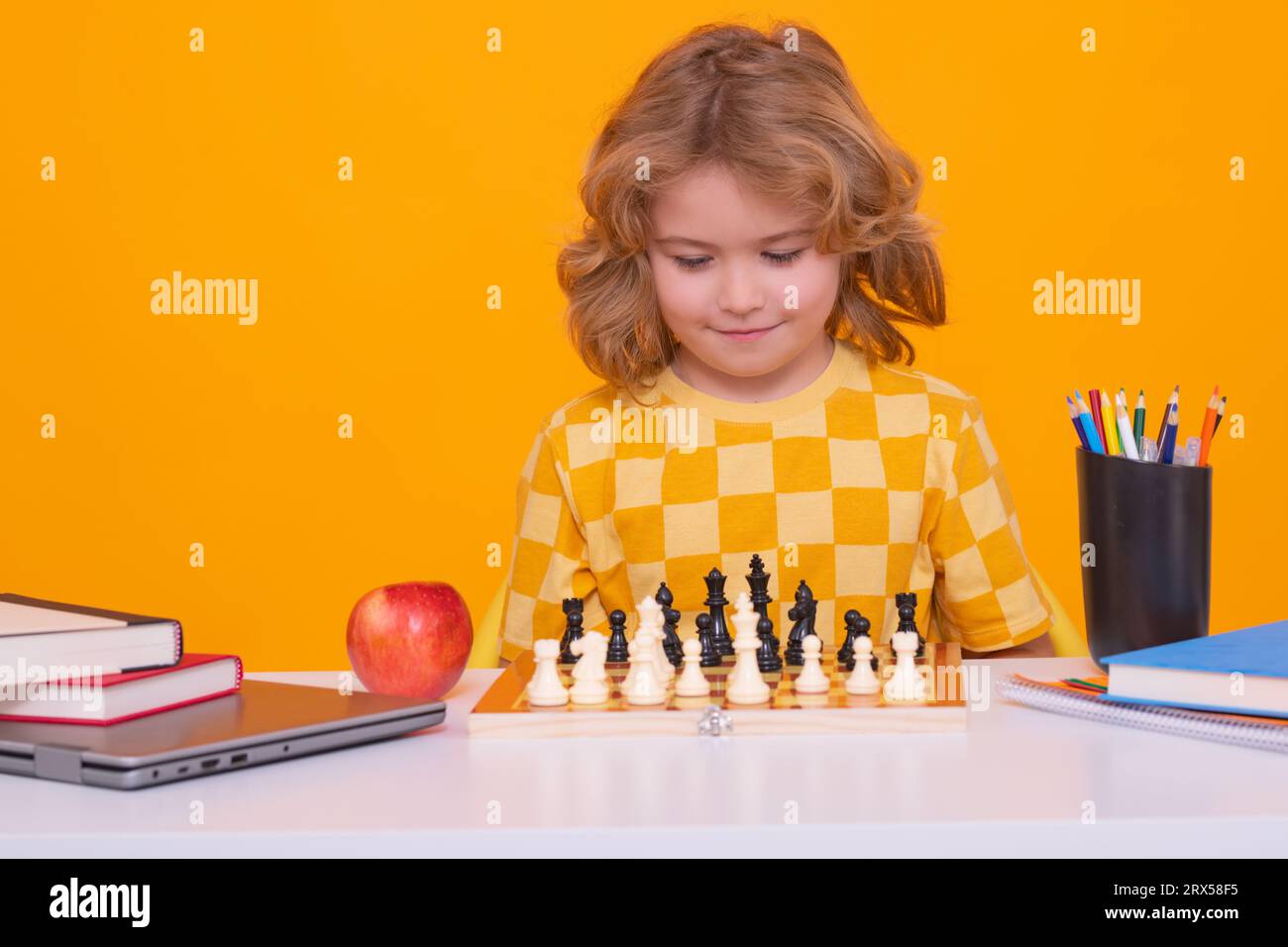 Kid thinking about chess. The concept of learning and growing children ...