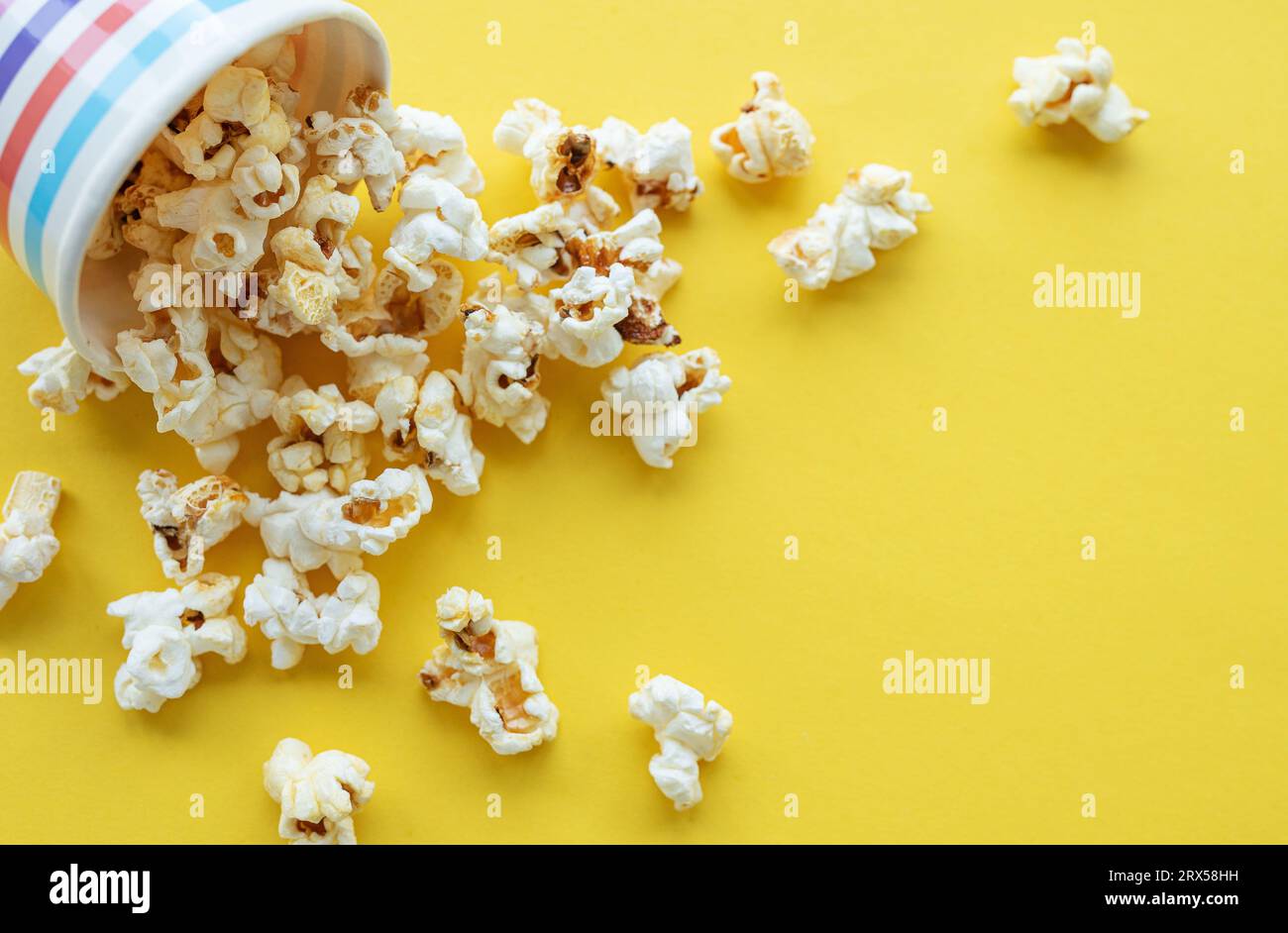 Popcorn paper bucket on yellow background Stock Photo - Alamy