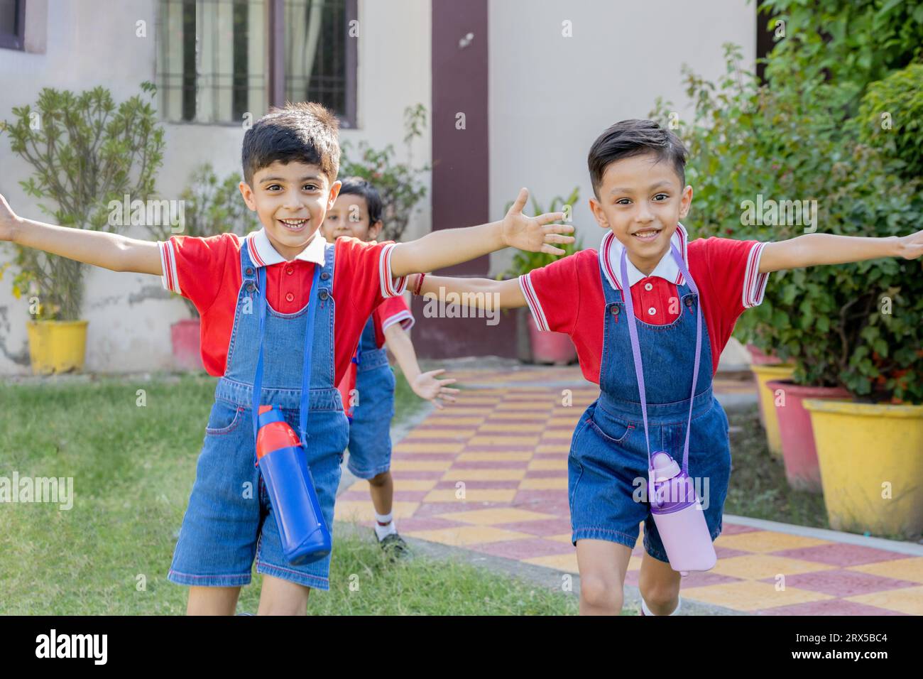 Happy indian school kids playing outside the primary school Looking at ...