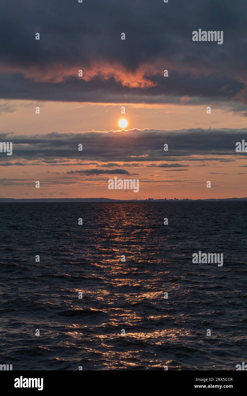 The setting sun light up the horizon Stock Photo - Alamy