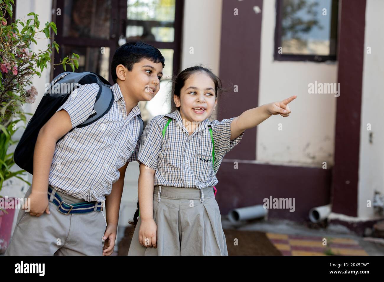 Happy indian school kids student pointing at something outside the ...