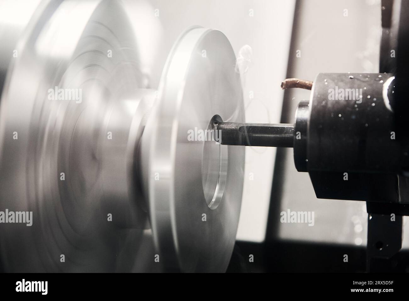 CNC lathe machine or turning machine cutting parts at the steel shaft ...