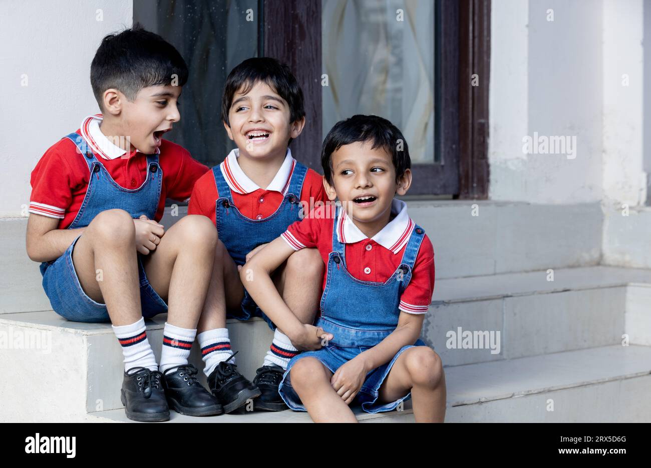 Happy indian boys student sitting together outside the school and ...