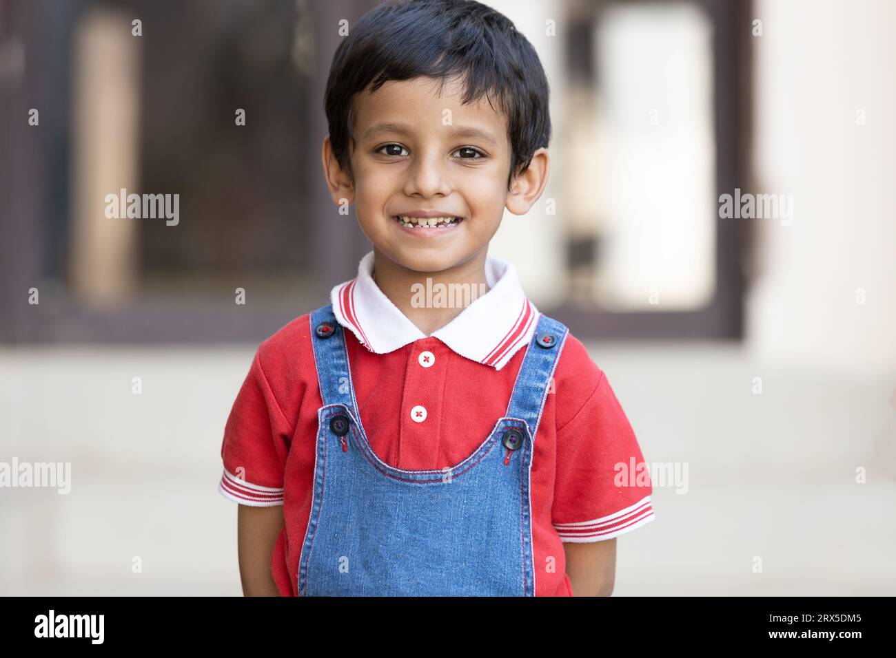 Portrait of happy indian boy student wearing school uniform standing ...