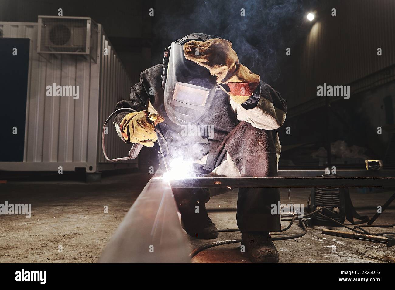 Male in face mask welds with welding Stock Photo - Alamy
