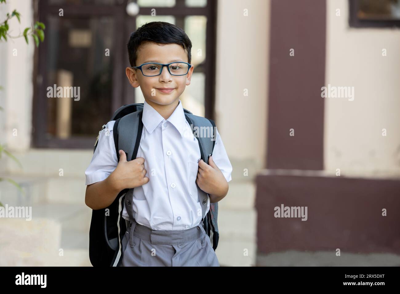 Portrait of happy indian boy student wearing school backpack standing ...