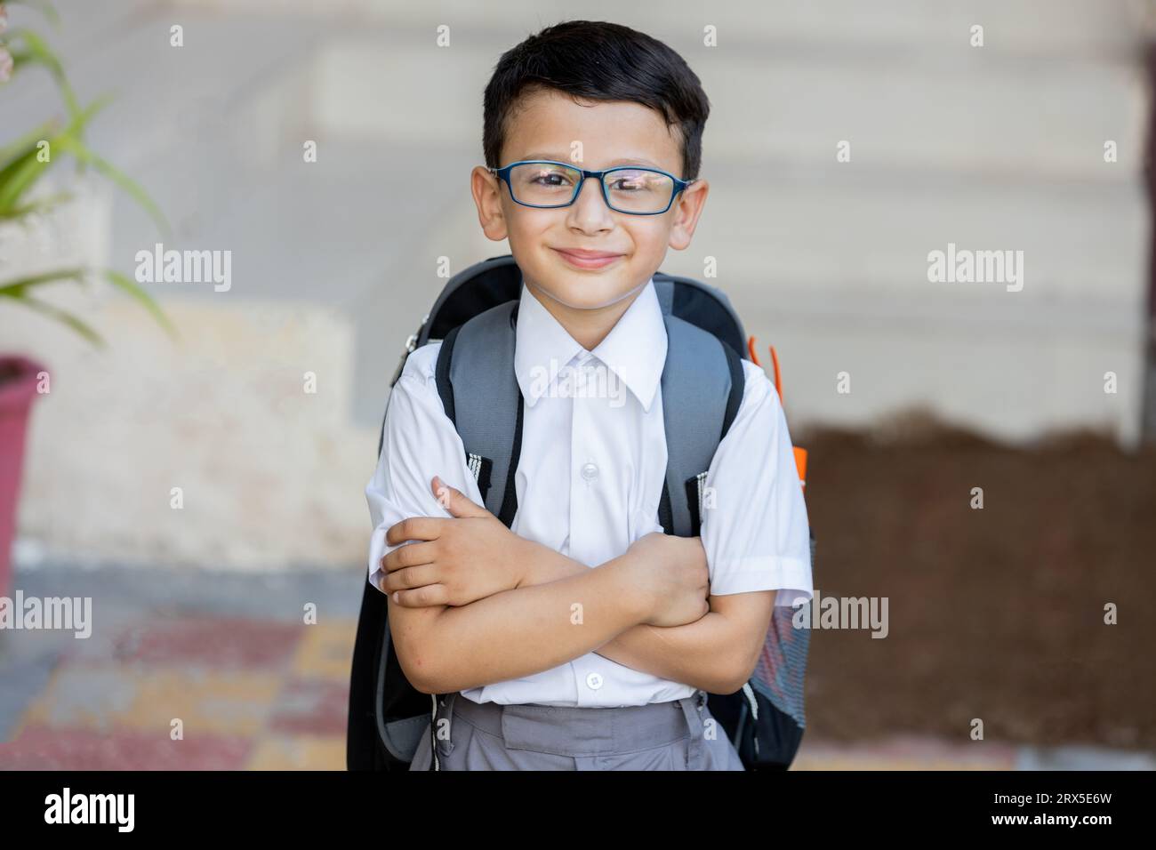 Portrait of happy indian boy student wearing school backpack standing ...