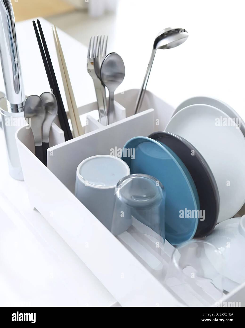 clean dish in the box in kitchen interior Stock Photo - Alamy