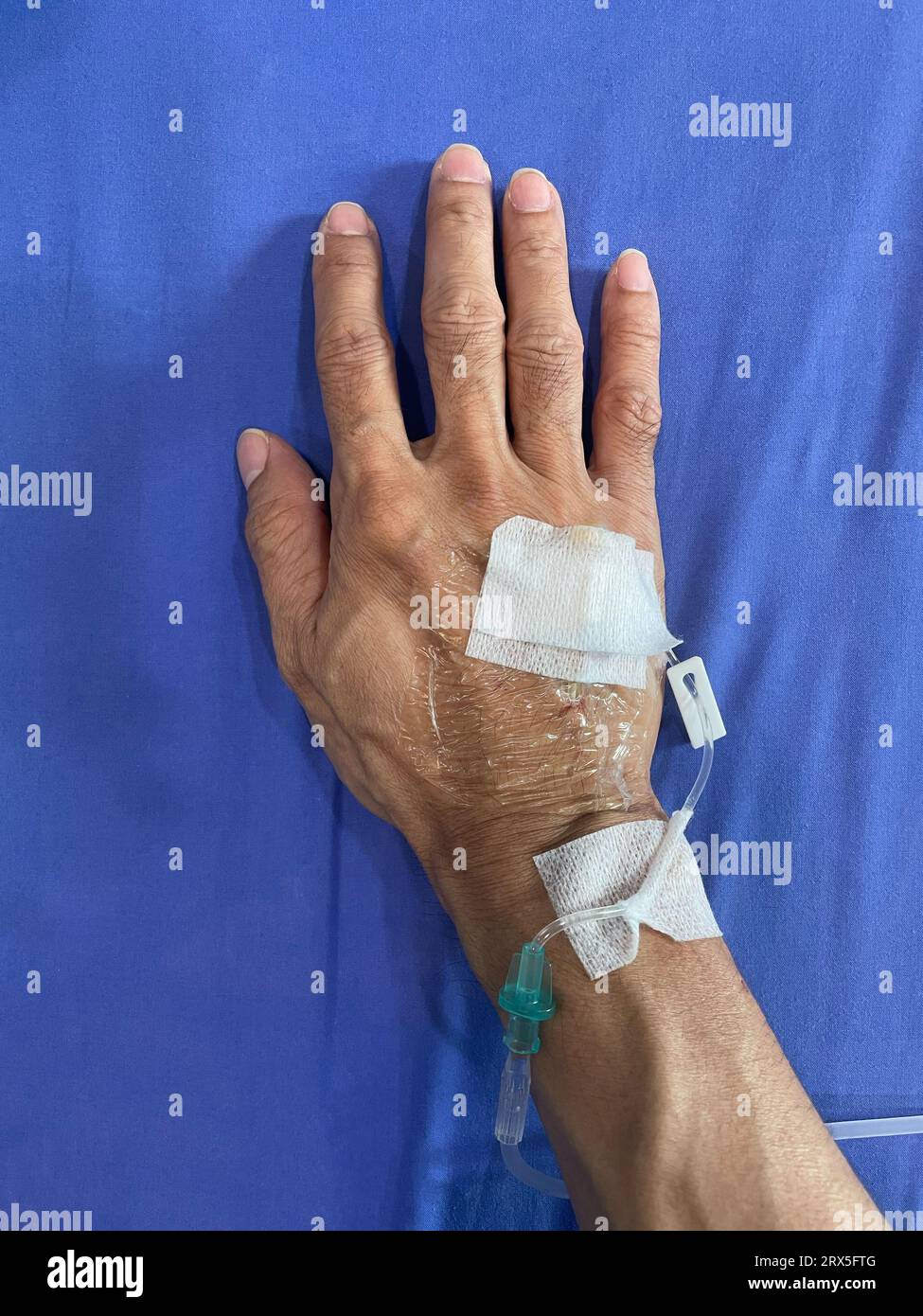 Intravenous line of saline infusion for patient lying on the bed ...