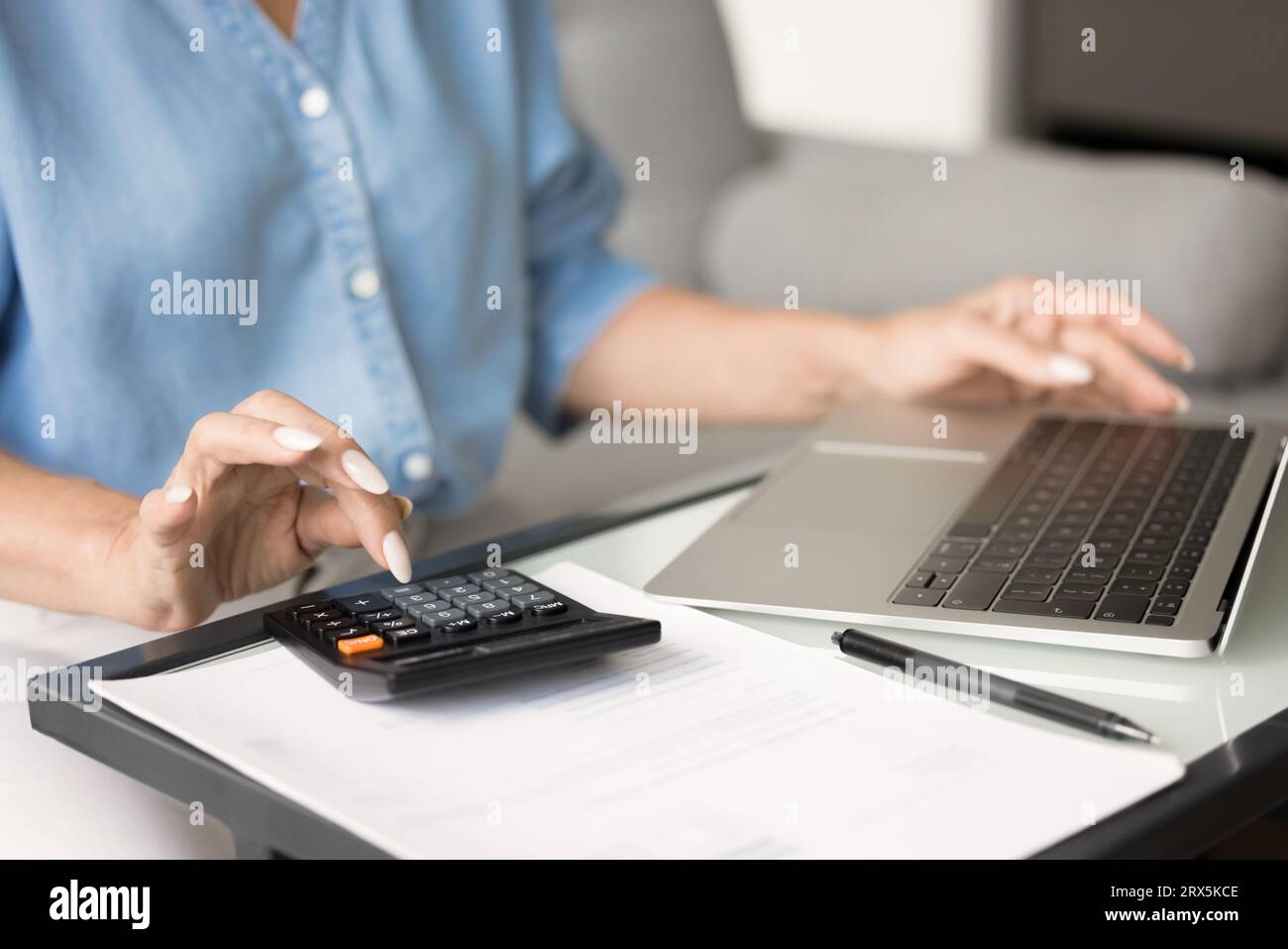 Hands of mature accountant lady typing on calculator and laptop Stock ...
